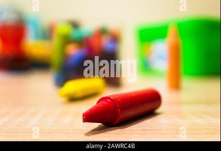 Colorful crayons on the ground in the kids' playing room Stock Photo ...