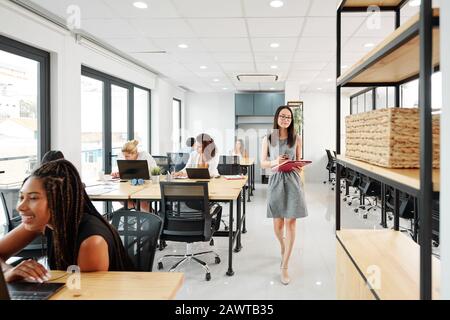 businesswoman with smartphone and folder at office Stock Photo - Alamy