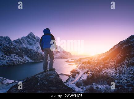 Man standing on mountain against sky Stock Photo - Alamy
