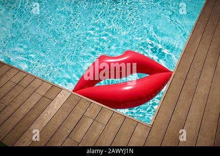 Inflatable lips floating in sunny summer swimming pool Stock Photo - Alamy