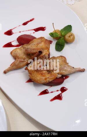 Still life with fried quail, red wine and cranberry sauce Stock Photo ...