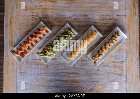High angle shot of different trays of sushi next to each other Stock ...