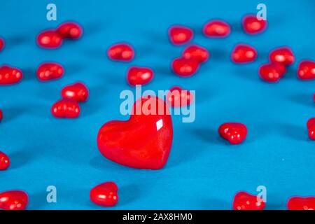 A scattering of love hearts, taken on a bright blue background, with ...