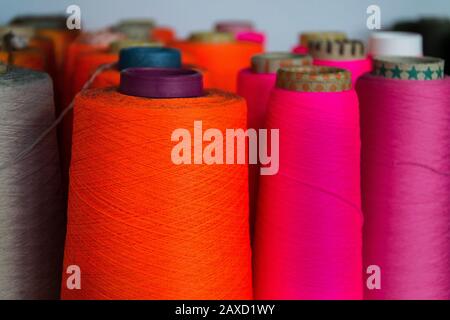 Colorful thread reels set up for sewing machine, textile industry ...