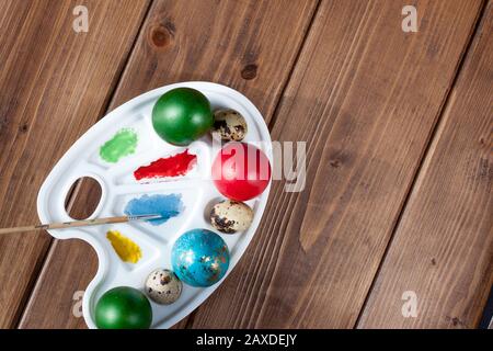 Colored eggs and paint on a wooden table, Easter background Stock Photo ...