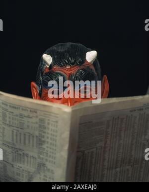 Man with devil mask reading a newspaper, Germany Stock Photo - Alamy