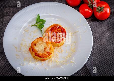 Italian rondelli with pomodoro sauce and cheese on rustic background ...