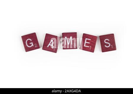 "Fun and Games" spelled out in wooden letter tiles. Surrounded by dice ...