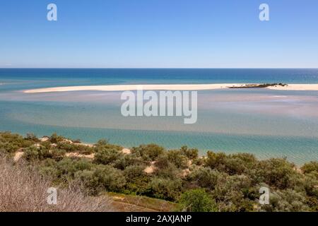 Coastal wooded landscape of pristine beaches and lagoon behind offshore ...