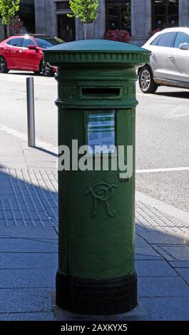 Irish green painted letter post box outside a traditional 19th century ...
