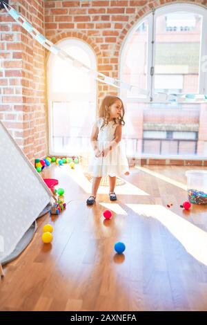 Adorable blonde toddler playing with building blocks around lots of ...