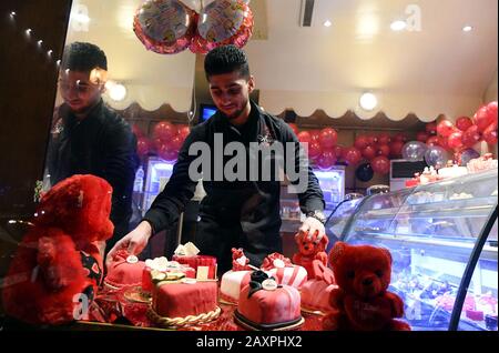 Damascus, Syria. 12th Feb, 2020. A sweet maker shows a cake on the ...