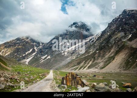 A view of the broken road leading to the mountains Stock Photo - Alamy