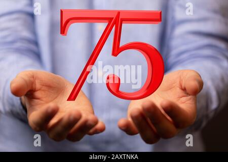 Red number of 75 over someone's hands Stock Photo - Alamy