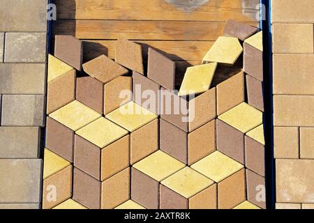 Laying yellow concrete paving slabs. Sidewalk or patio tile or slabs on ...
