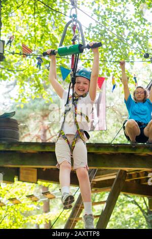 People zipping down Zip Line setup over Uptown Mall shopping center at ...