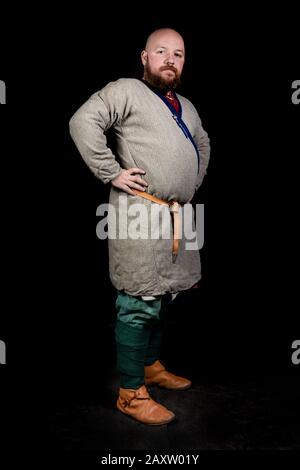 Overweight bearded man in the image of a medieval merchant Stock Photo ...