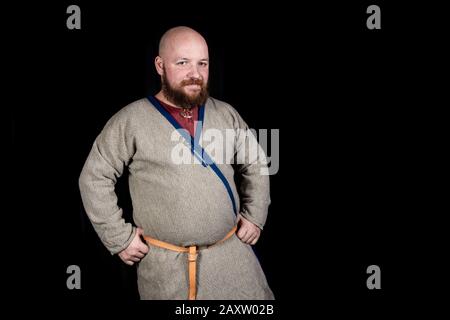 Overweight bearded man in the image of a medieval merchant. The ...
