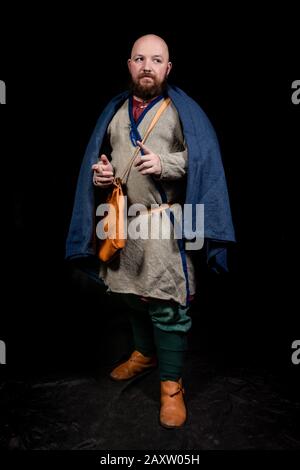 Overweight bearded man in the image of a medieval merchant Stock Photo ...
