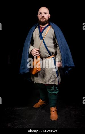 Overweight bearded man in the image of a medieval merchant Stock Photo ...