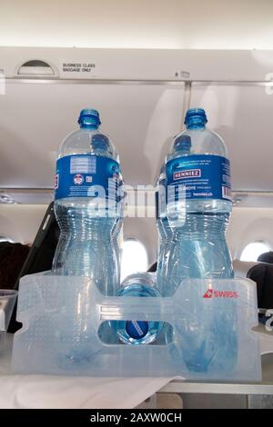 A man delivers plastic bottles of water during a hot day in Istanbul ...