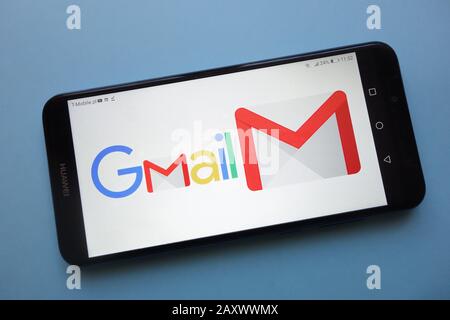 The logo of the Gmail is displayed on a smartphone screen, and the ...