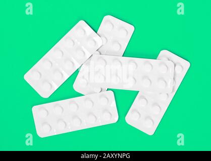 Pill strip isolated on a green background Stock Photo - Alamy
