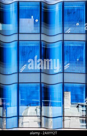 contemporary glass office building with wavy facade under construction ...