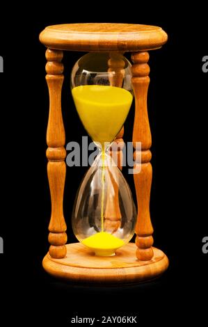 Wooden hourglass isolated on the balck background Stock Photo - Alamy