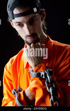 Inmate chained on black background Stock Photo - Alamy