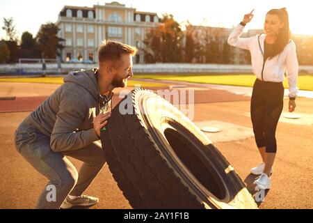 Man and woman doing outdoor fitness training together at a park ...