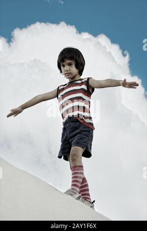 Child climbing and balancing on rope course obstacles in treetop ...
