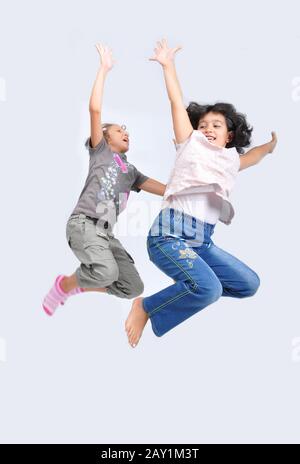 Two adorable Little Girl Jumping, Dancing, Having Fun Outdoor. Children ...