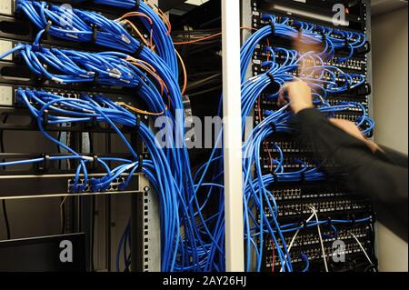 Man fixing server in data center room Stock Photo - Alamy