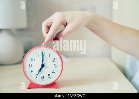 Female hand with alarm clock at home, closeup. Daylight saving time ...