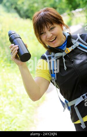 Wanderin drinks from a drinking bottle Stock Photo - Alamy