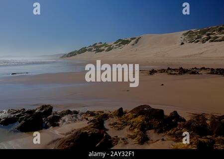 Majestic view of the beach next to the towering sand dunes of Sardinia ...