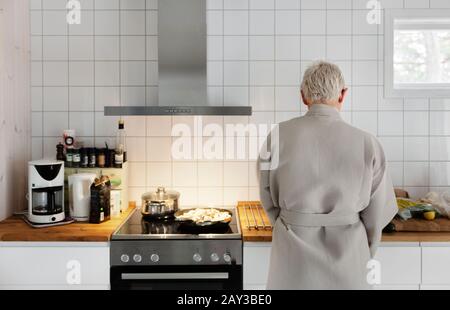 Rear view of man preparing food in barbecue at forest Stock Photo - Alamy
