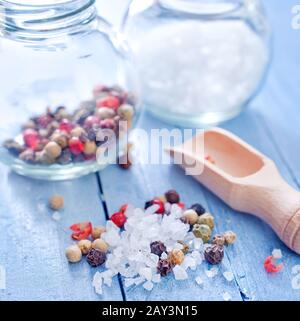 Sea salt and red hot pepper with bay leaf and colorful peppercorns on ...