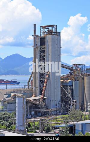 View of the cement plant with pipes. Industrial factory with smoke frow ...