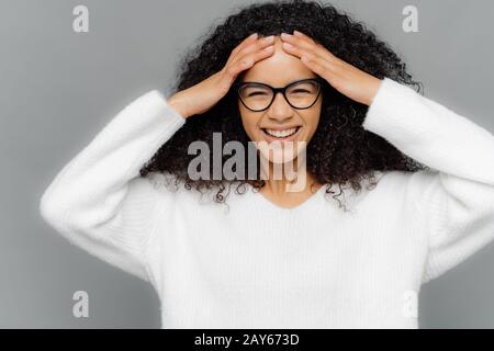 Portrait of optimistic brunette curly lady dance wear spectacles blue ...