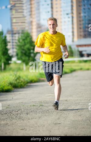 Sporty man jogging in a park Stock Photo - Alamy