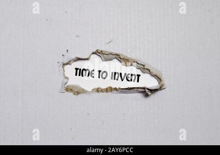 The word time to invent appearing behind torn paper Stock Photo - Alamy