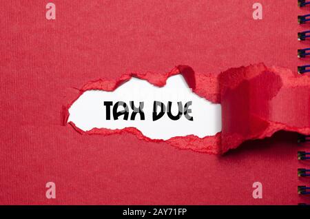 The word tax due appearing behind torn paper Stock Photo - Alamy