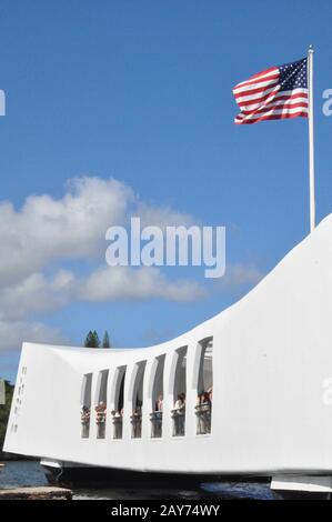 Visitors to the USS Arizona Memorial view a wall bearing the names of ...