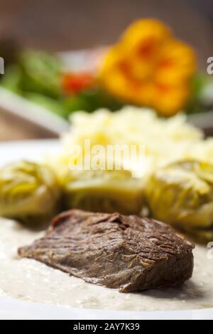 Boiled beef with horseradish and potato salad Stock Photo - Alamy