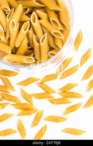Penne pasta in a glass bowl on wooden background Stock Photo - Alamy