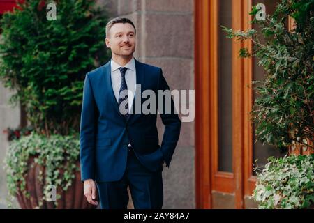 Young male employee in time management concept Stock Photo - Alamy