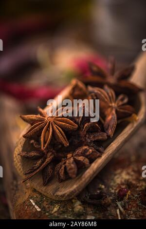 Whole anise stars on wooden spoon Stock Photo - Alamy