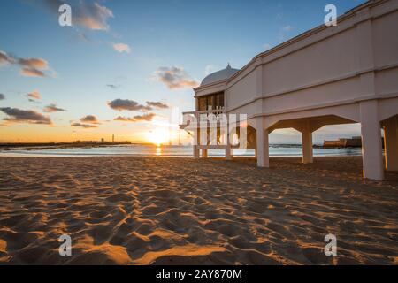 Romantic sunset at Cadiz beach with famous pier Stock Photo - Alamy
